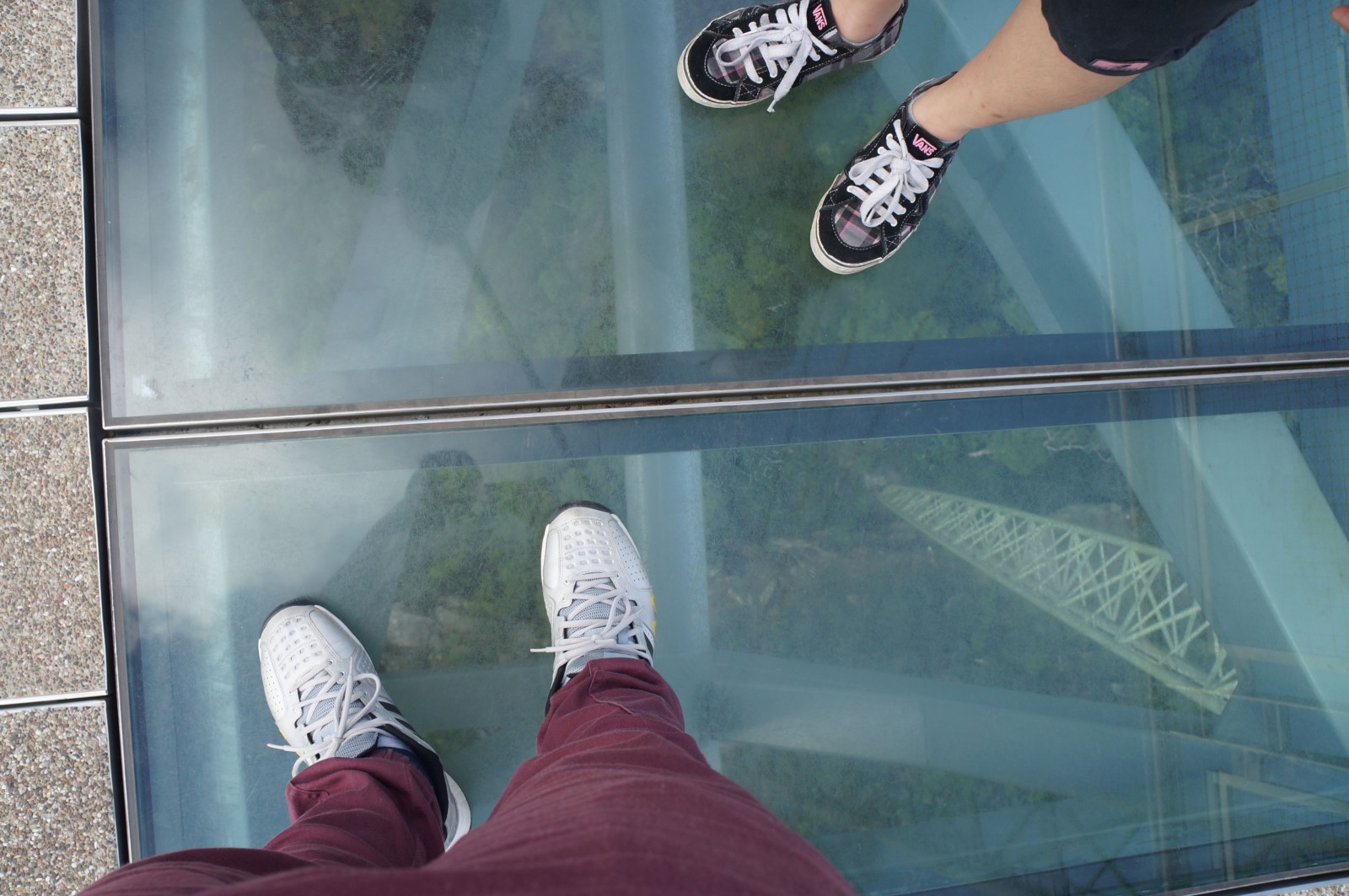 The glass flooring on the SkyBridge allows patrons to view below - R ...